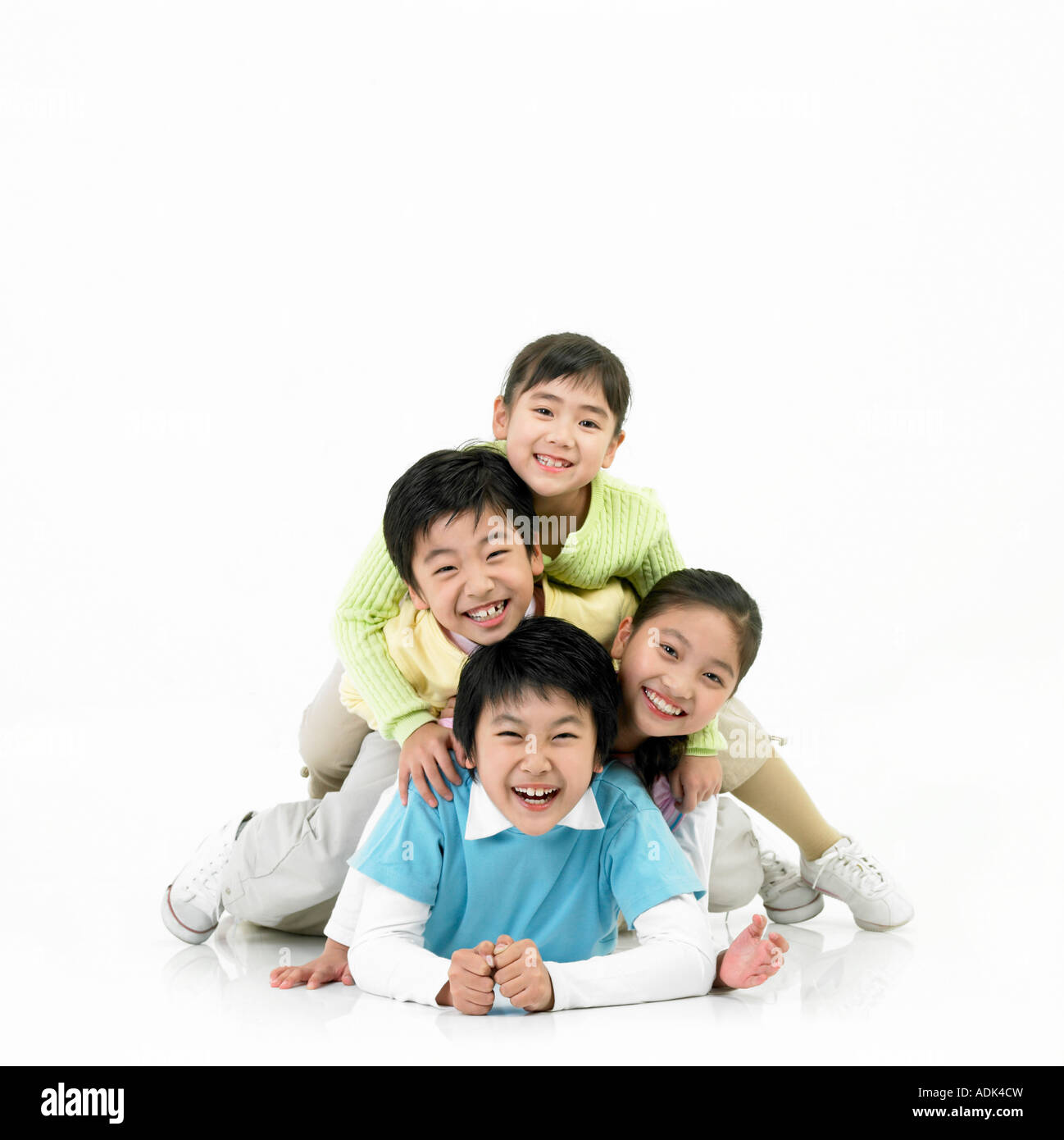 girls and boys prostrating with a tower Stock Photo - Alamy