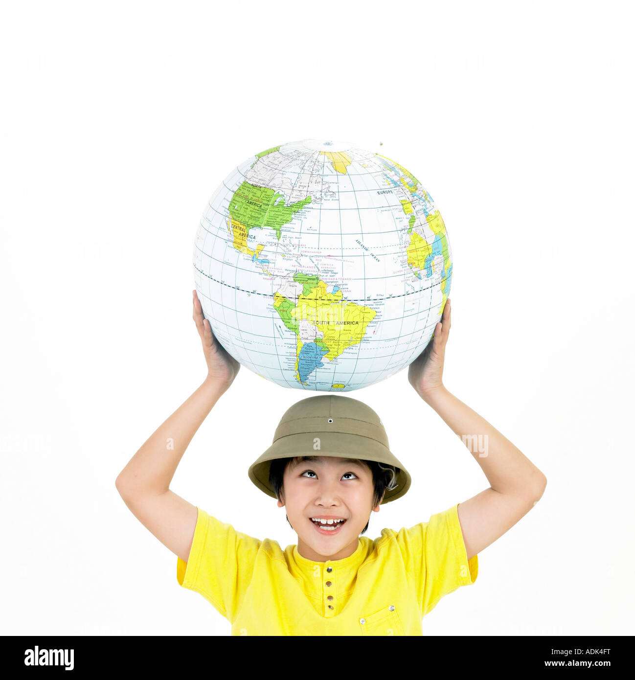 a boy holding a globe with a smile Stock Photo - Alamy