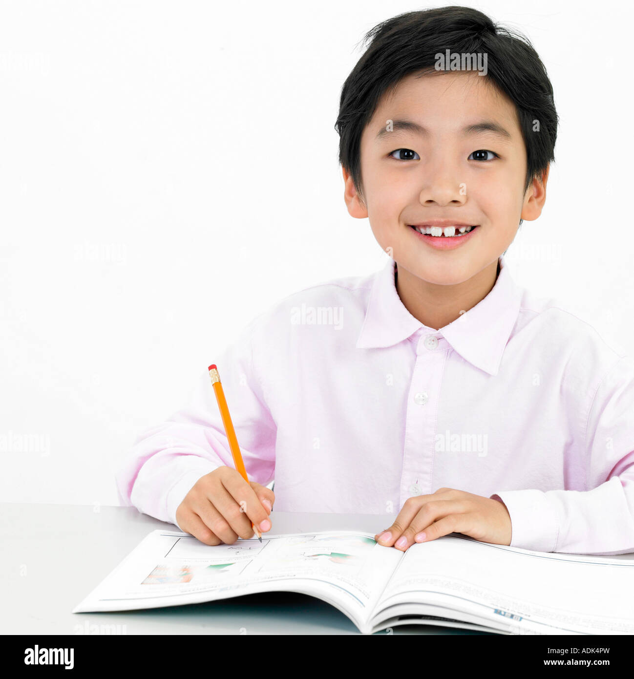a boy studying hard in class Stock Photo - Alamy