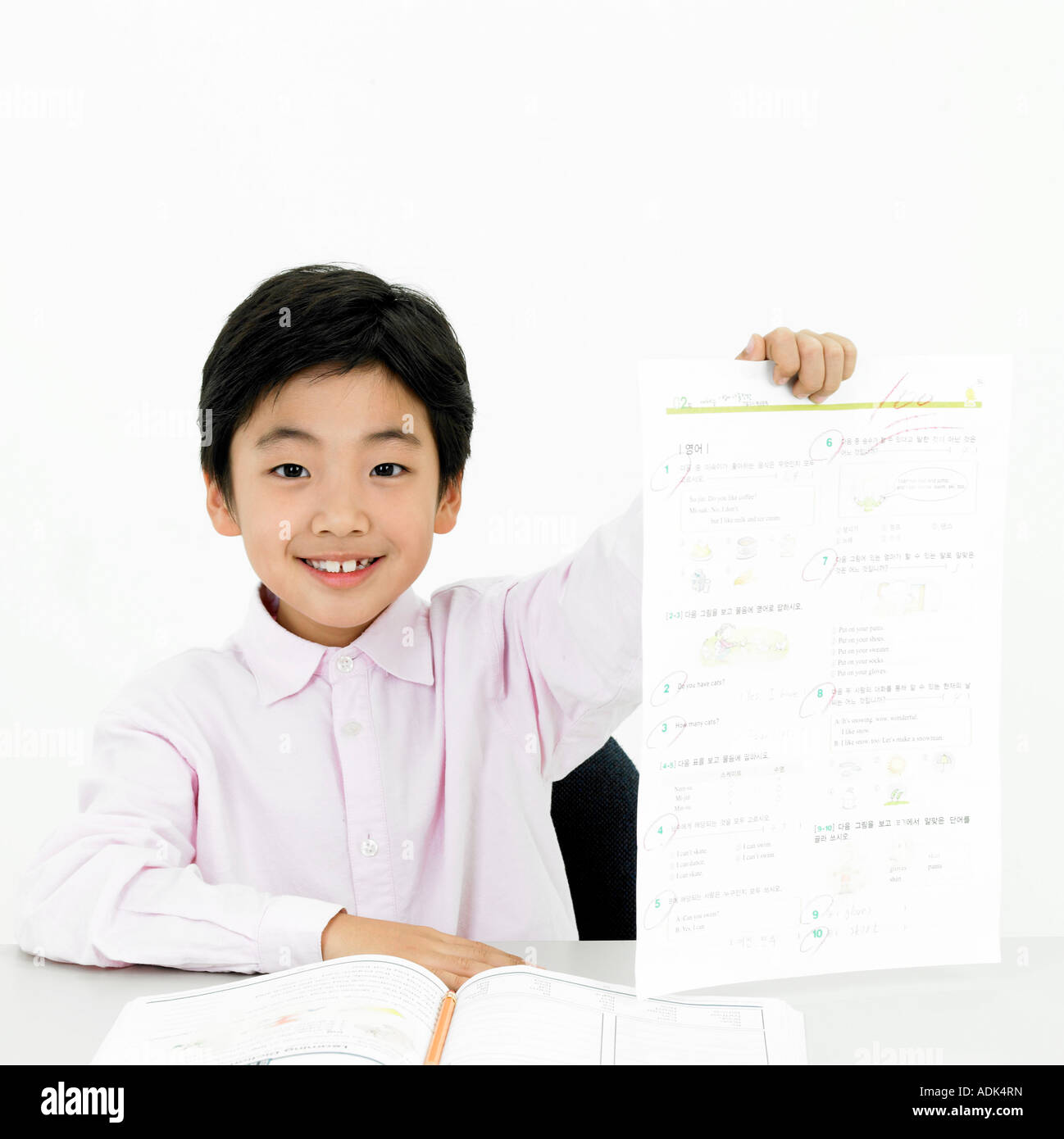 a boy showing his test paper in class Stock Photo - Alamy