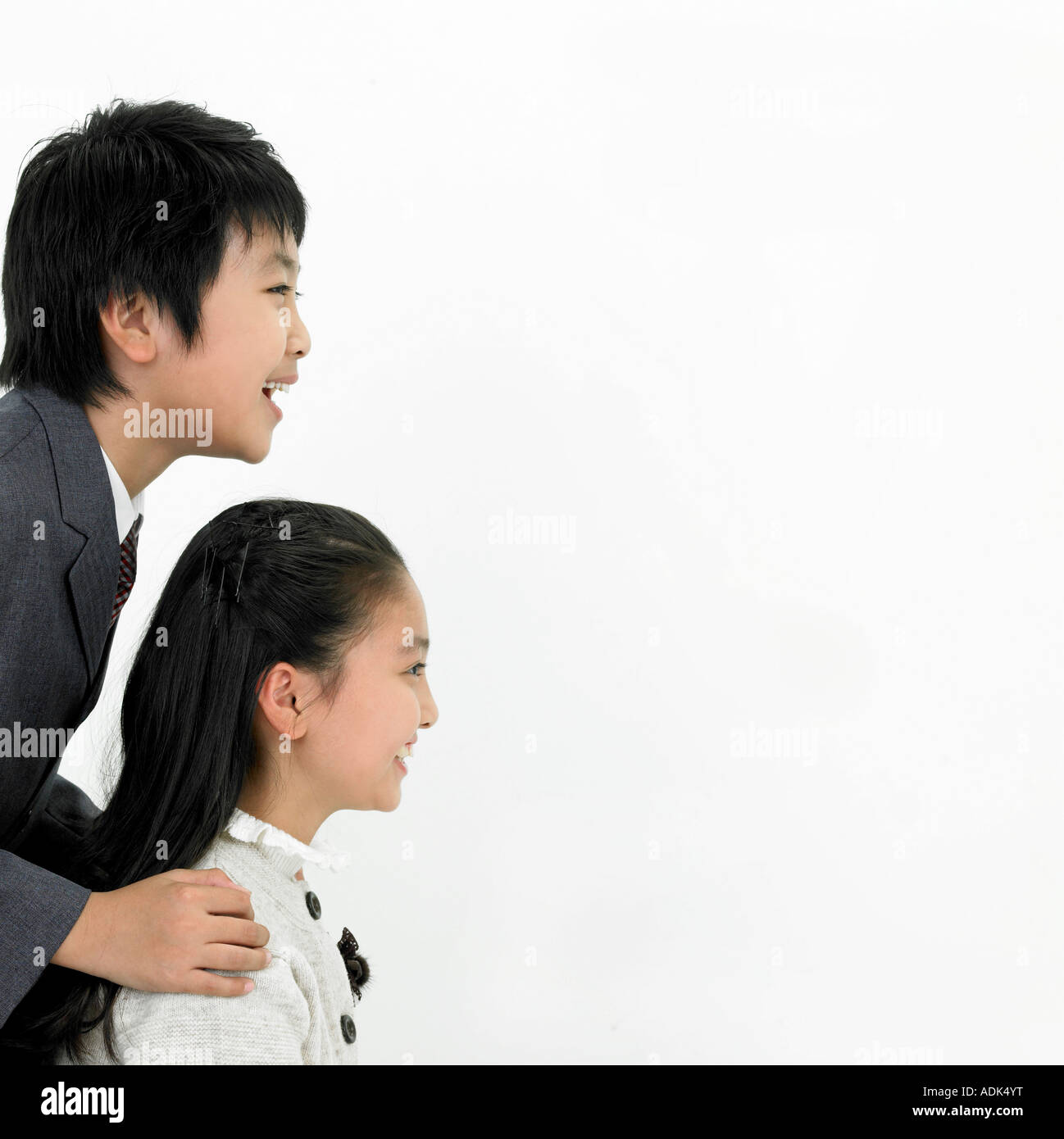 a boy and a girl making a smile in profile Stock Photo - Alamy