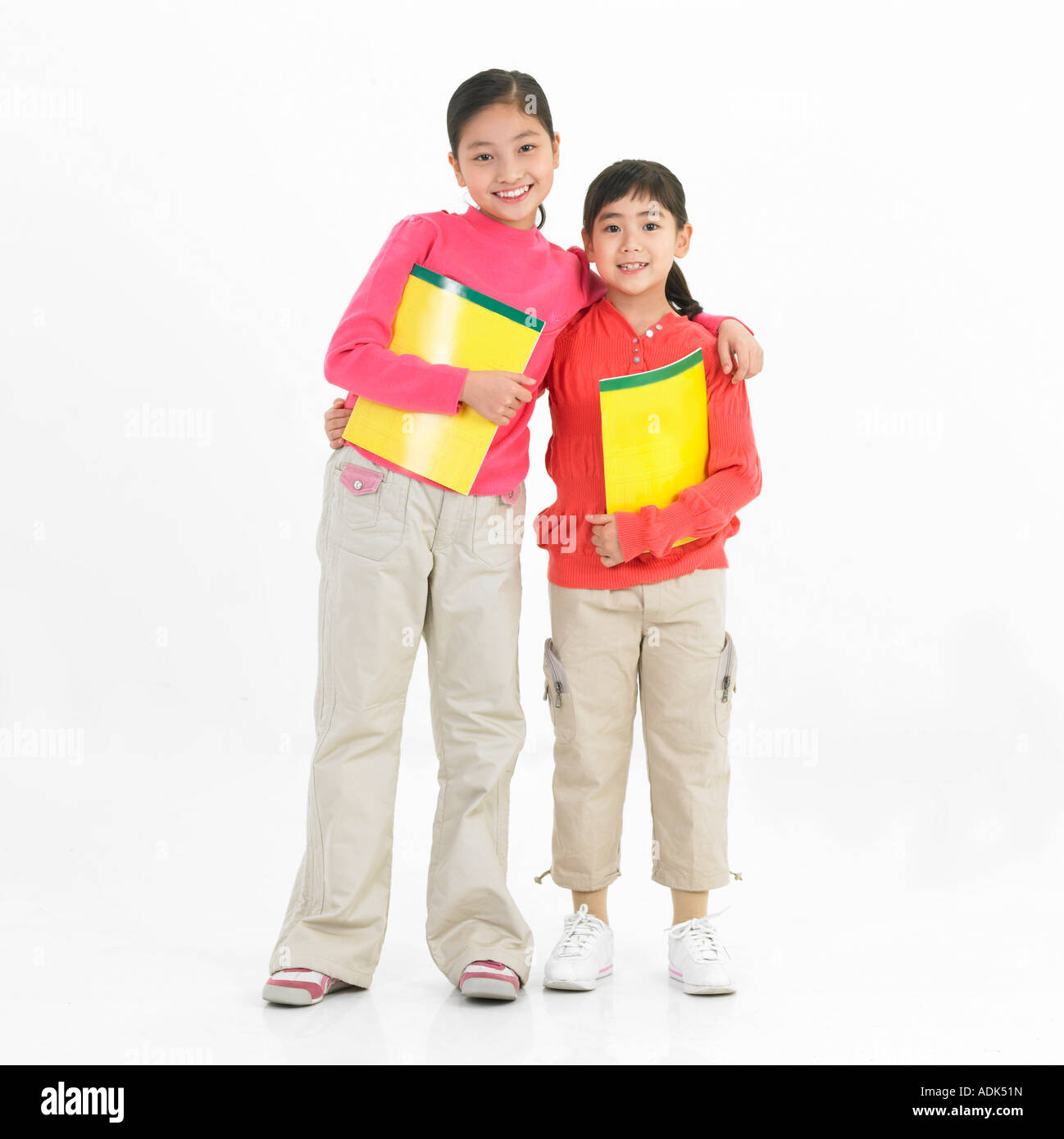 two girls putting arms around each other's shoulders Stock Photo - Alamy