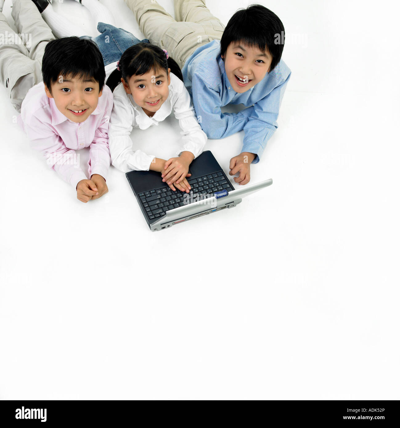 children falling prostrate with a notebook computer Stock Photo - Alamy