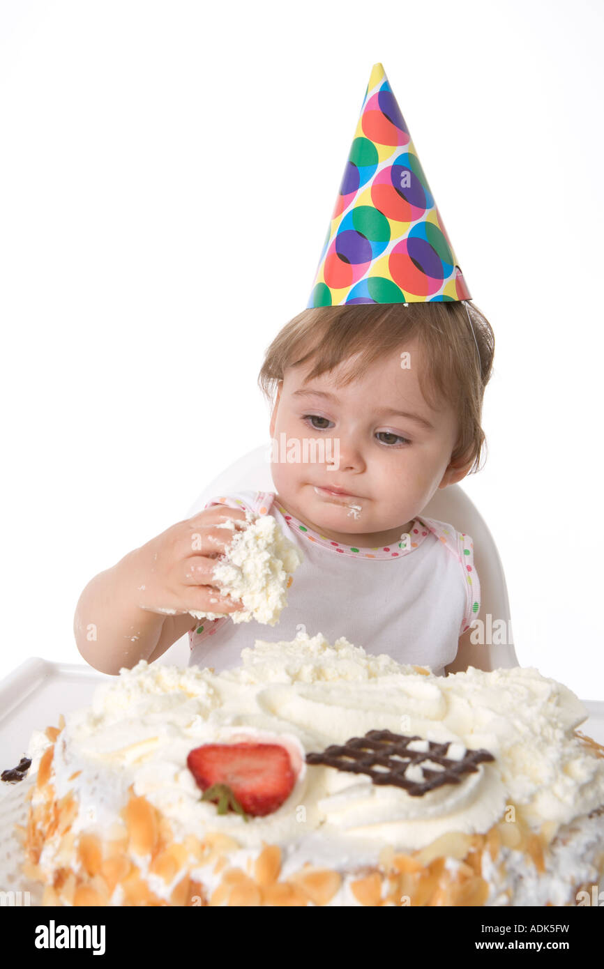 One year old baby girl eating from her birthday cake Stock Photo - Alamy