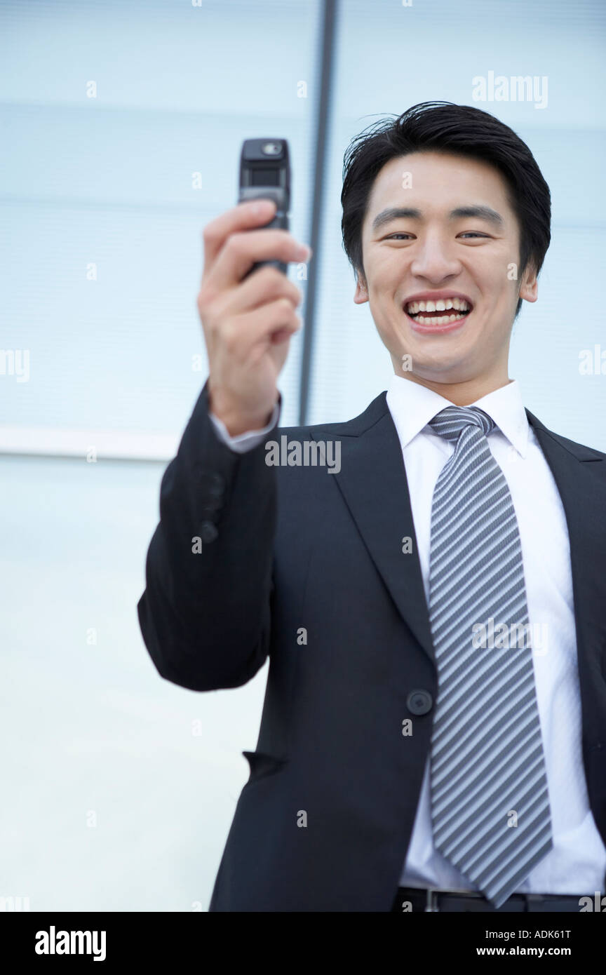 a businessman watching his mobile phone Stock Photo - Alamy