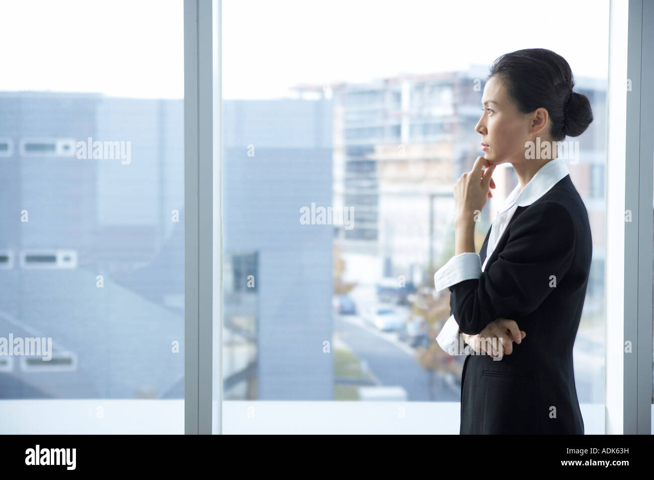 a businesswoman standing by the window Stock Photo - Alamy