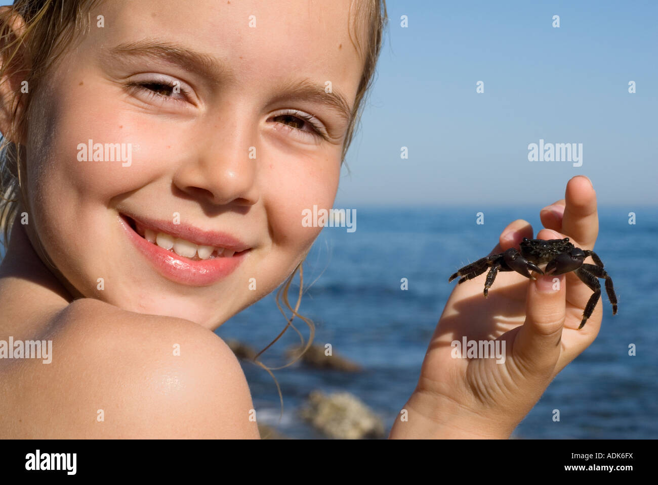 young girl with a crab in her hand Stock Photo - Alamy