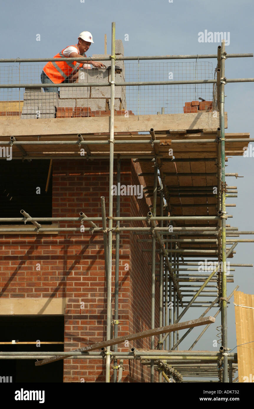 Housing being build Builder constructing a house Stock Photo - Alamy