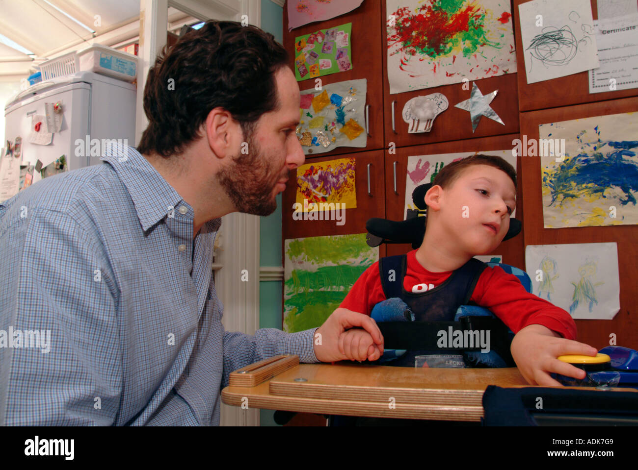 Father interacting with his disabled son London UK Stock Photo - Alamy