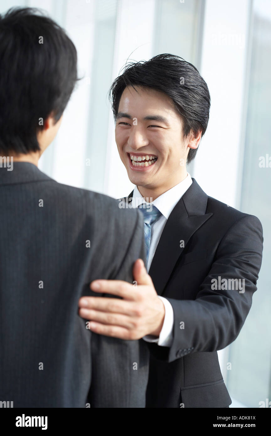 a businessman encouraging a man Stock Photo - Alamy