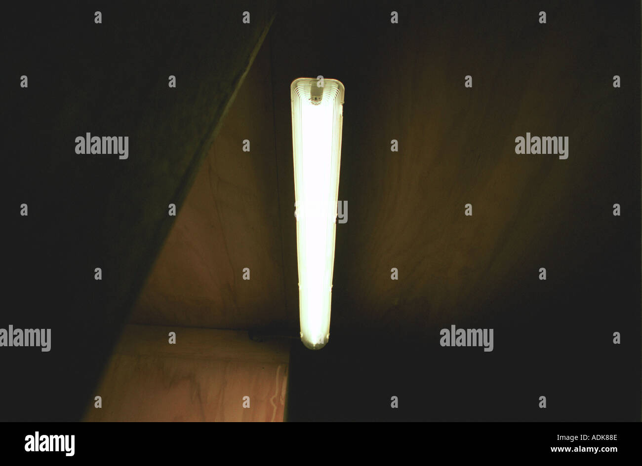 fluorescent light strip on boarded up area Stock Photo - Alamy