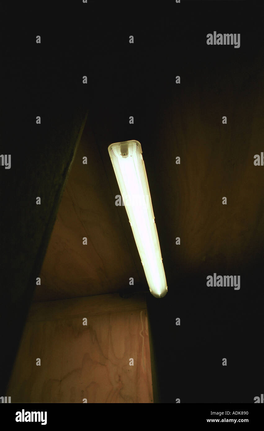 fluorescent light strip on boarded up area Stock Photo - Alamy