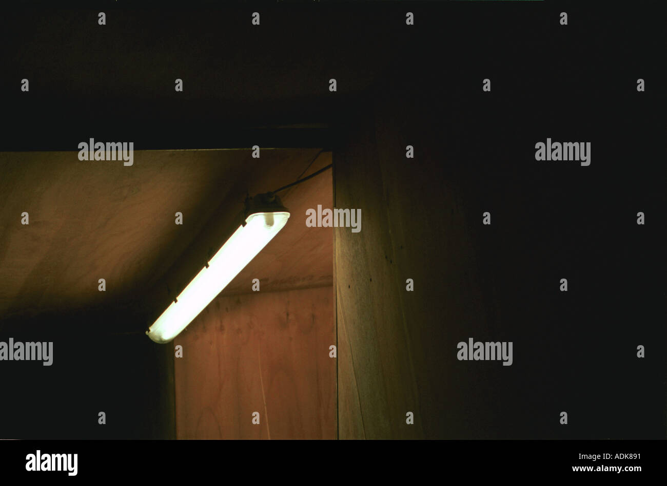 fluorescent light strip on boarded up area Stock Photo - Alamy