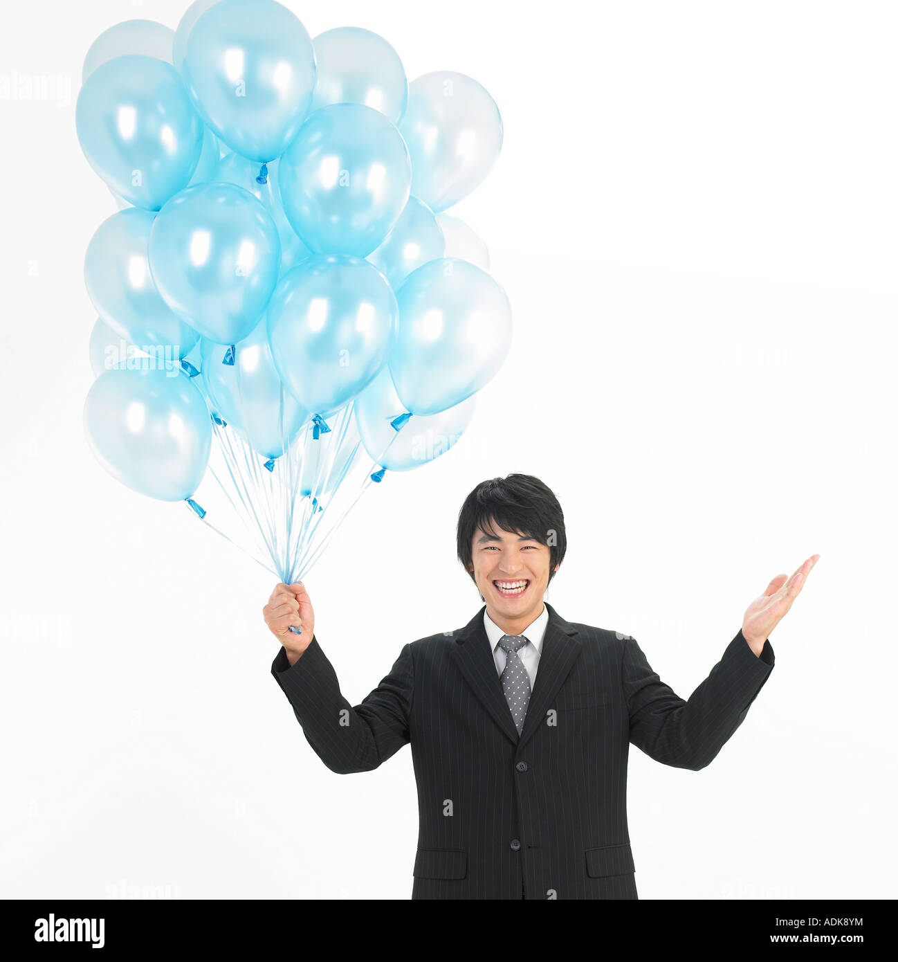 a businessman holding balloons Stock Photo - Alamy