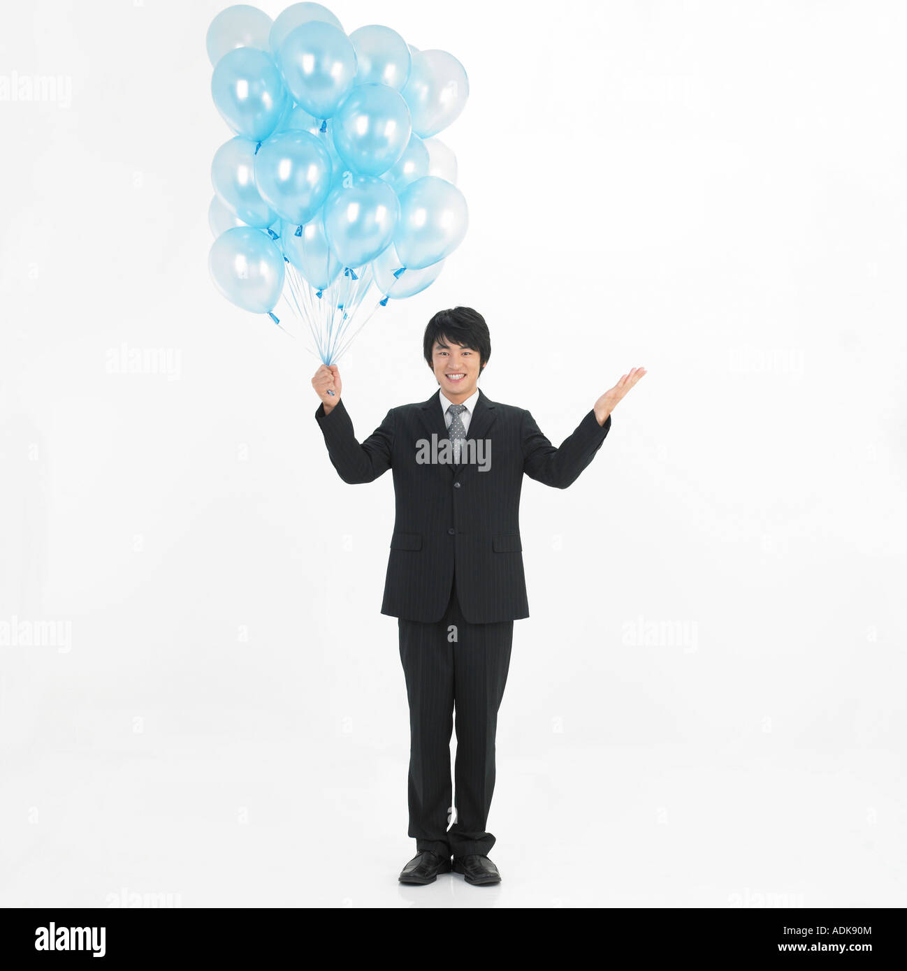 a businessman holding balloons Stock Photo - Alamy