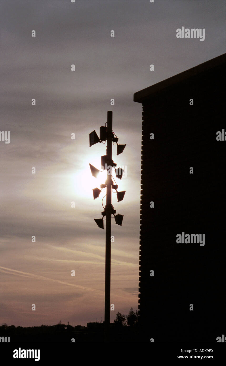 sunset building and lights on pole Stock Photo - Alamy