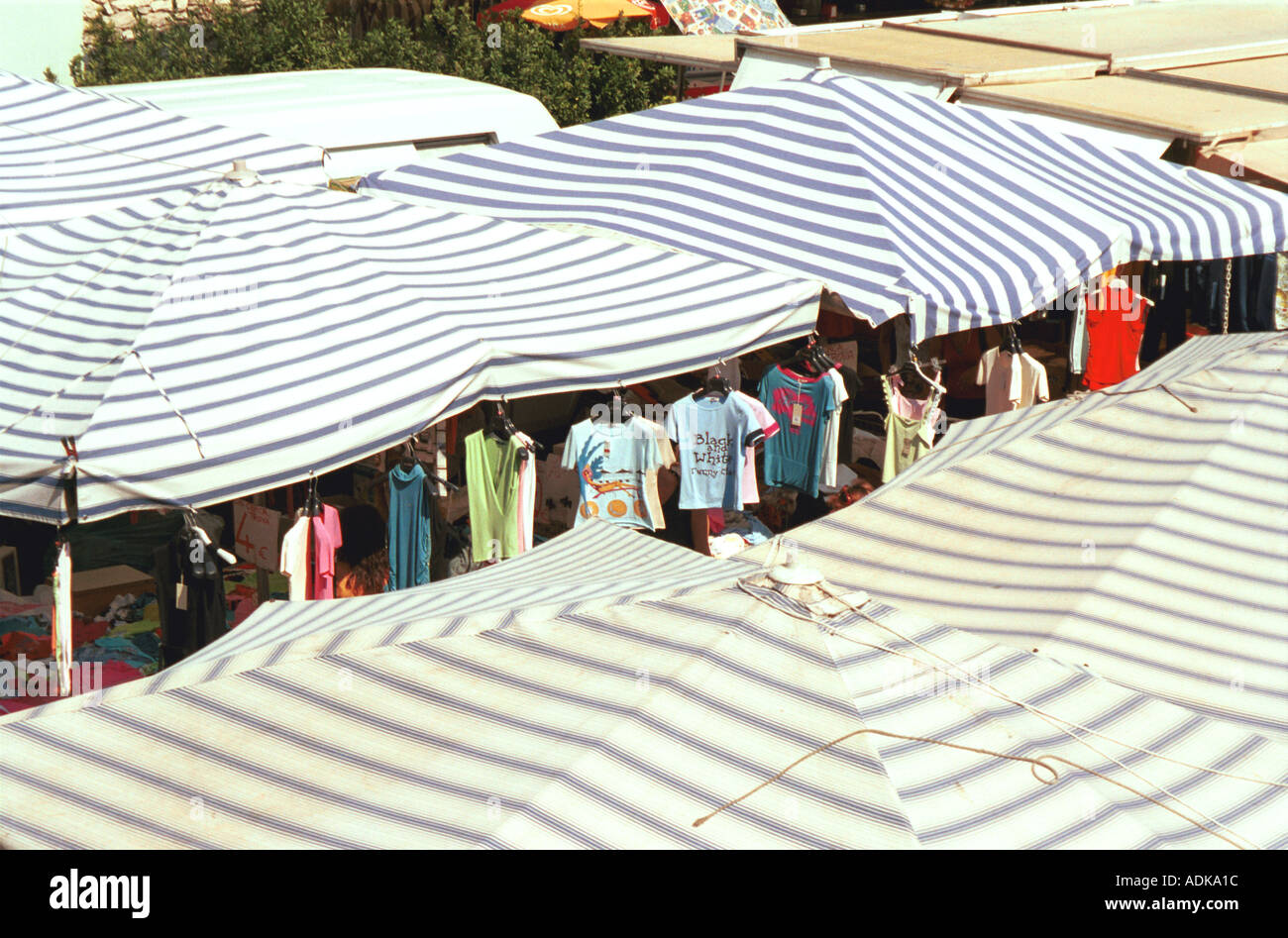 outside market with clothes hanging Stock Photo - Alamy