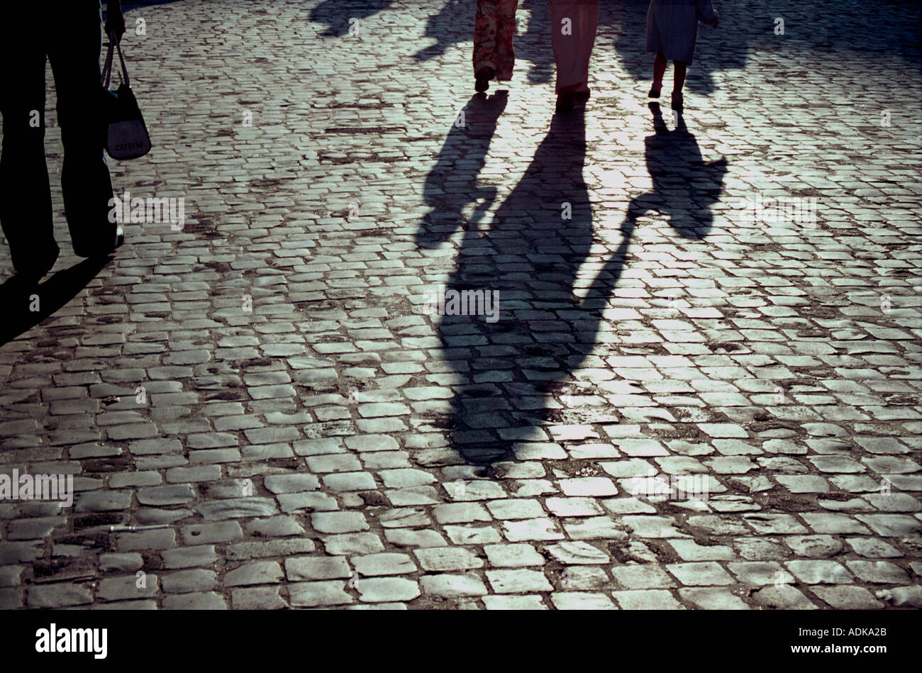 shadow of mum and two children on cobbles Stock Photo - Alamy