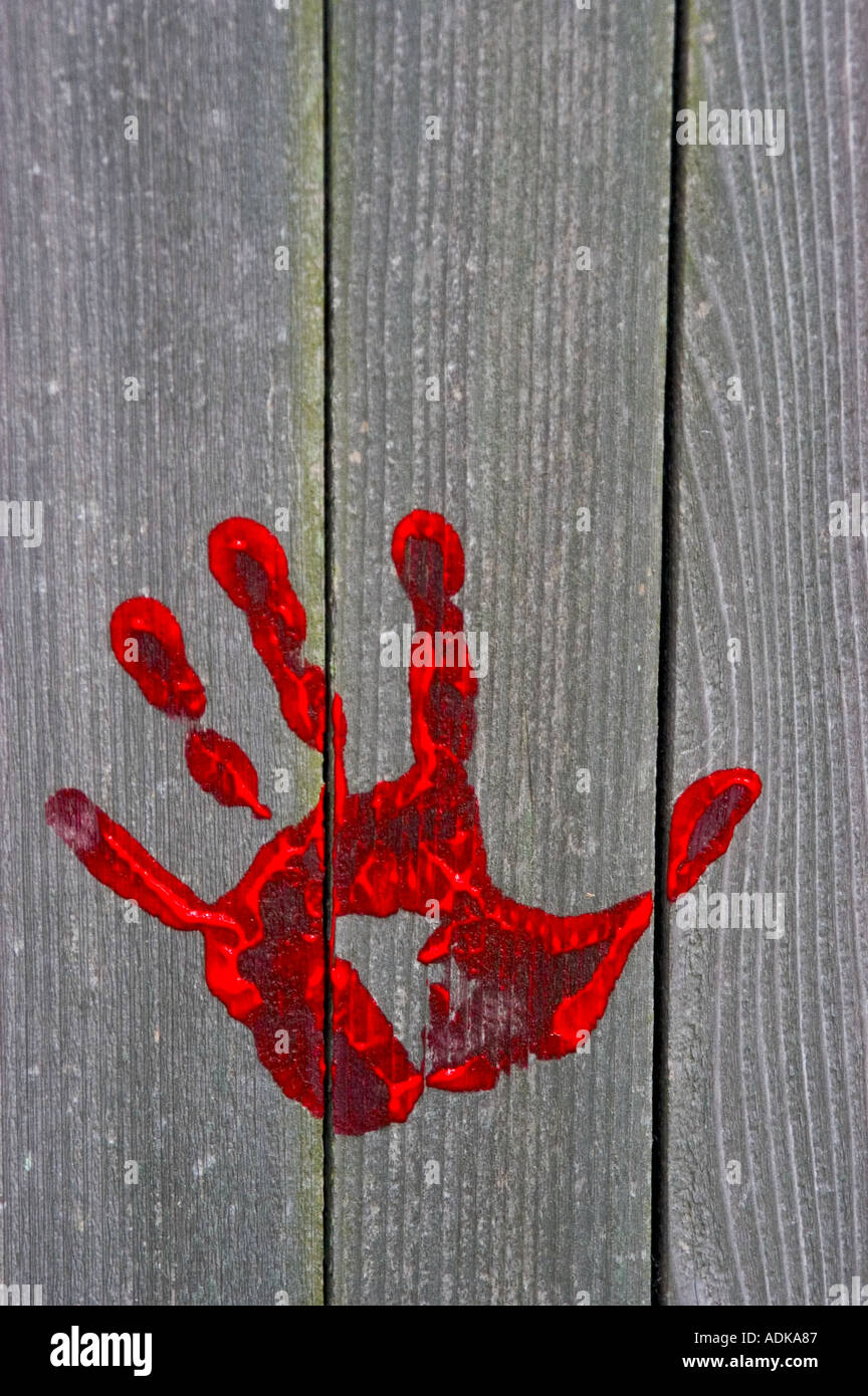 Red painted hand on wooden fence street gang sign Stock Photo - Alamy