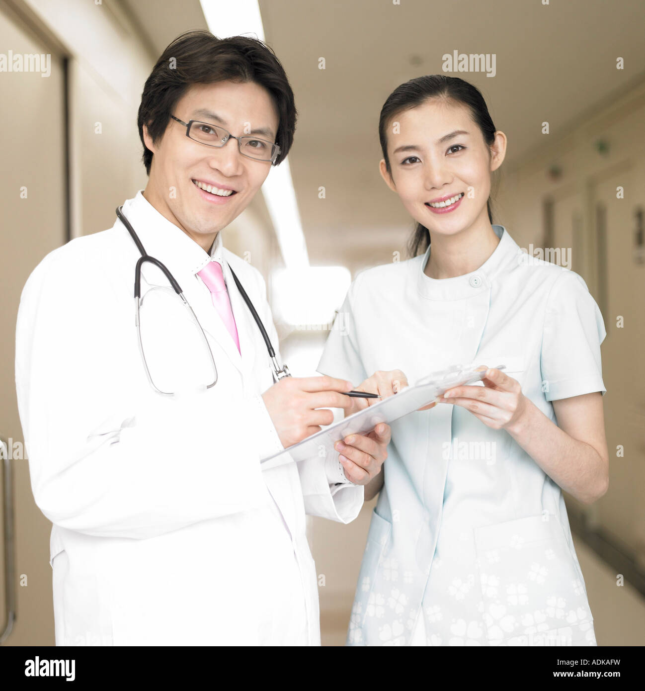 medicine a doctor and a nurse holding a medical chart Stock Photo - Alamy