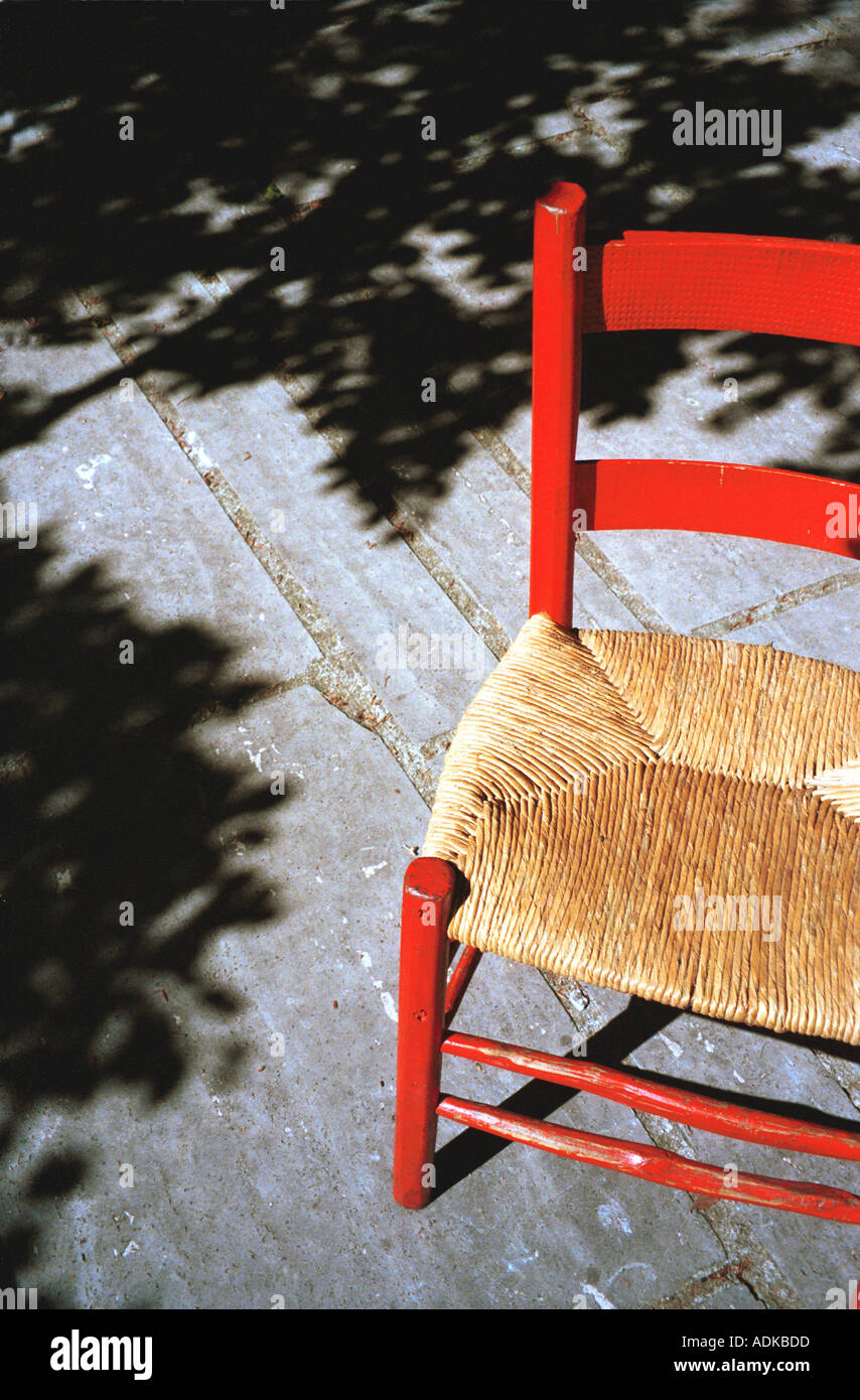red chair outside on patio Stock Photo - Alamy