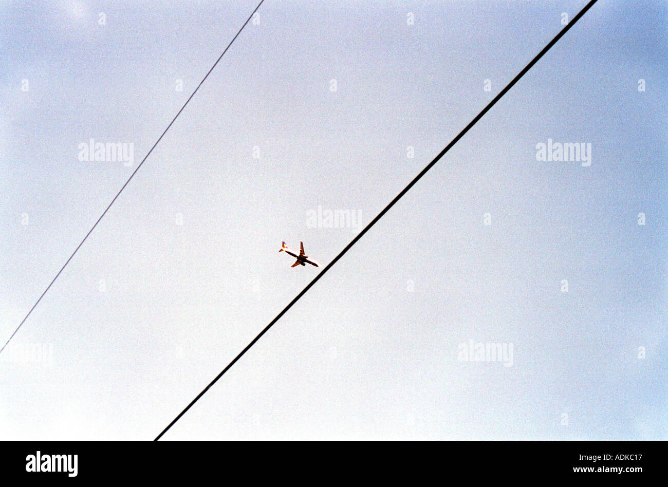 plane in sky with phone power lines Stock Photo - Alamy