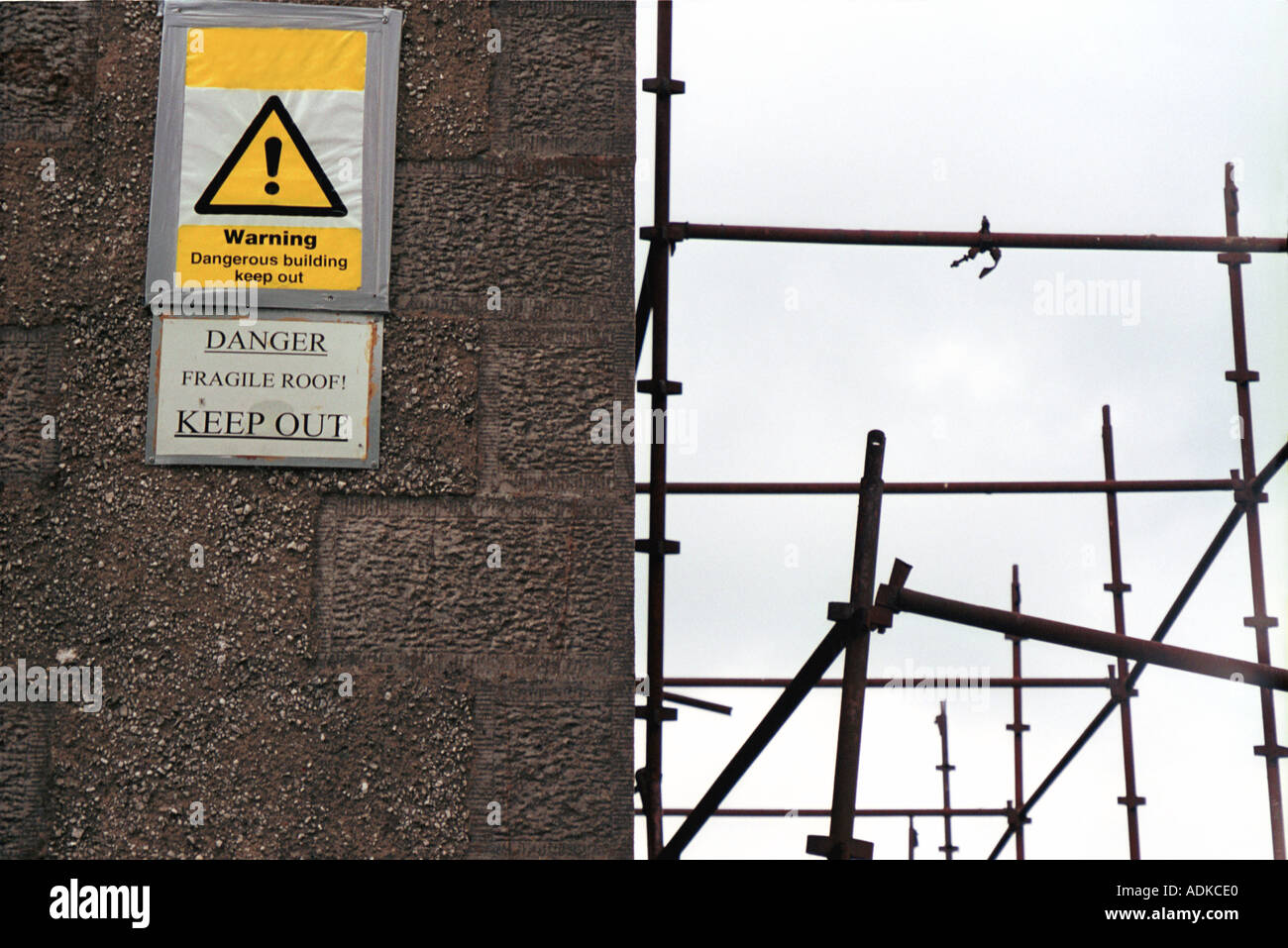 danger sign and scaffolding on unsafe building Stock Photo - Alamy