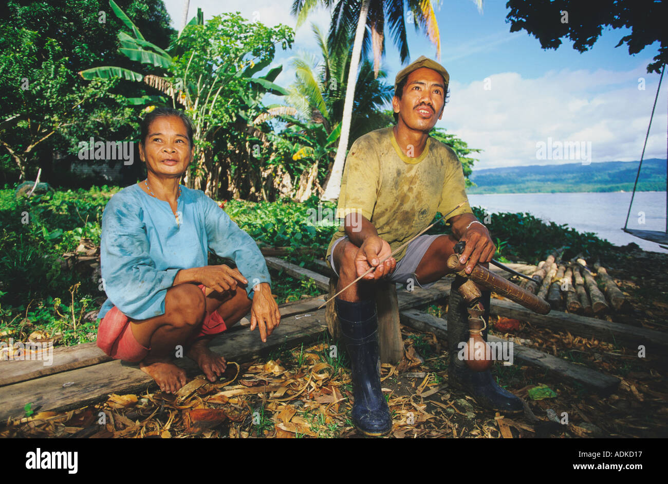Two Dyak people in Borneo East Kalimantan with blowpipe and poison ...