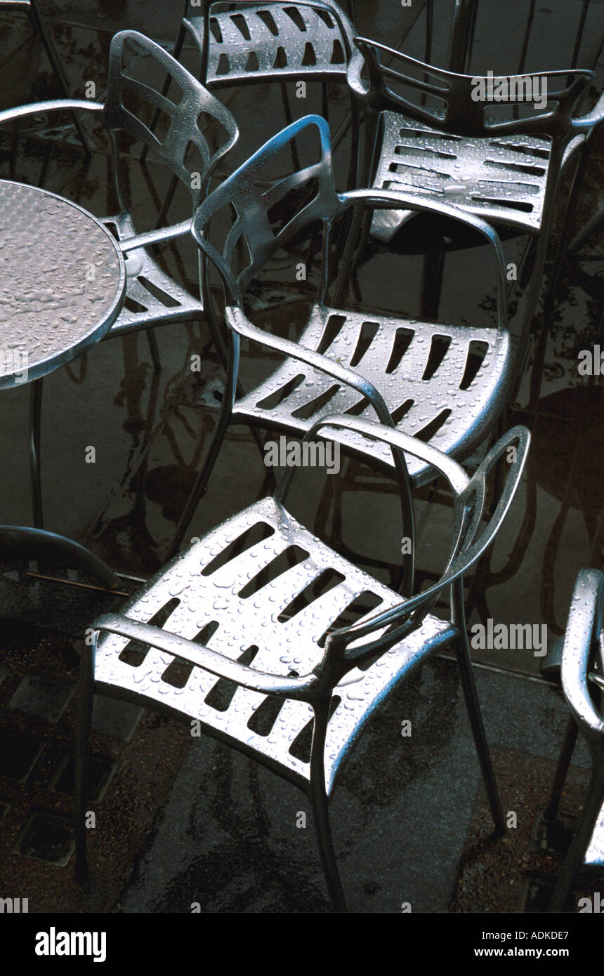 wet metal chairs and tables outside Stock Photo - Alamy