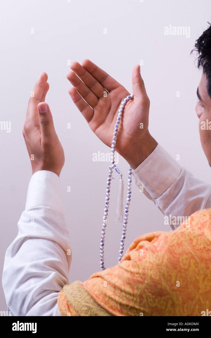 Man raising hands in prayer Stock Photo - Alamy