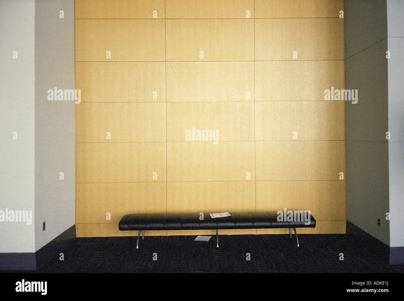 empty office bench centered betweeen two walls Stock Photo - Alamy