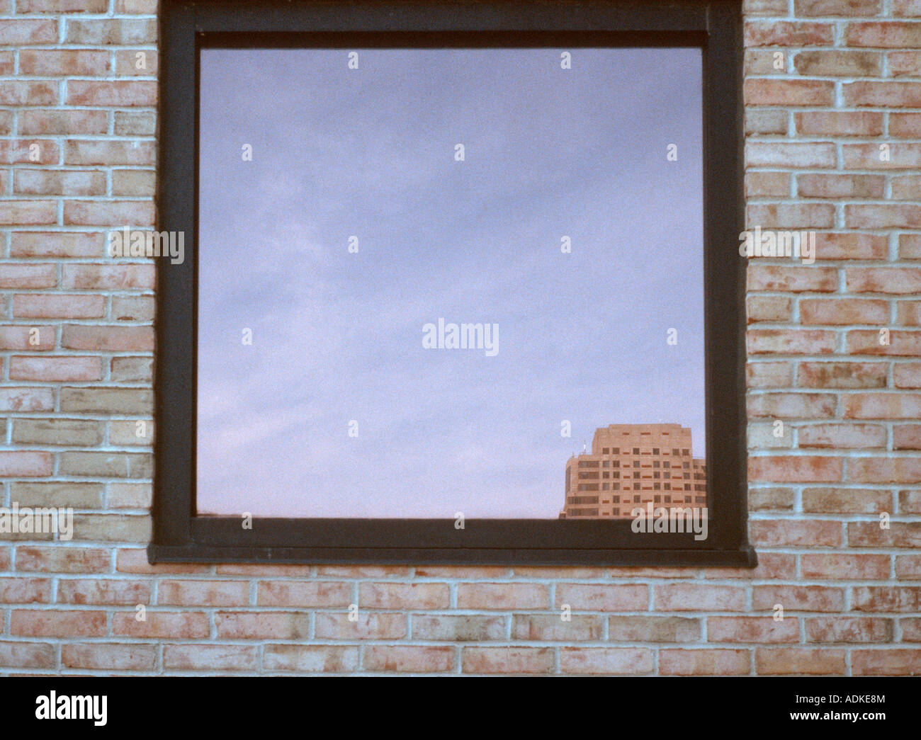 square window on brick wall with building reflected Stock Photo - Alamy