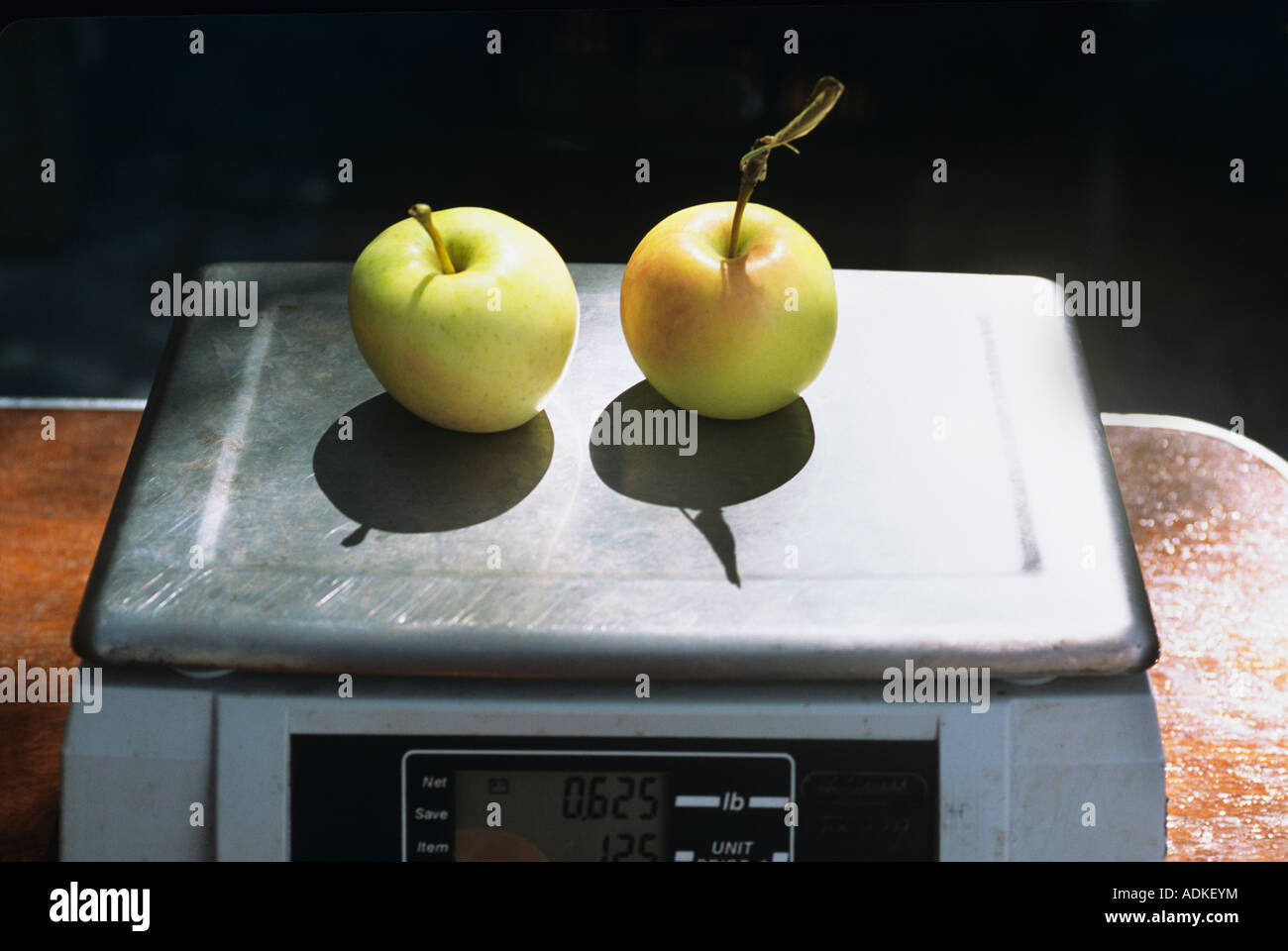 Two yellow apples on a scale Stock Photo - Alamy