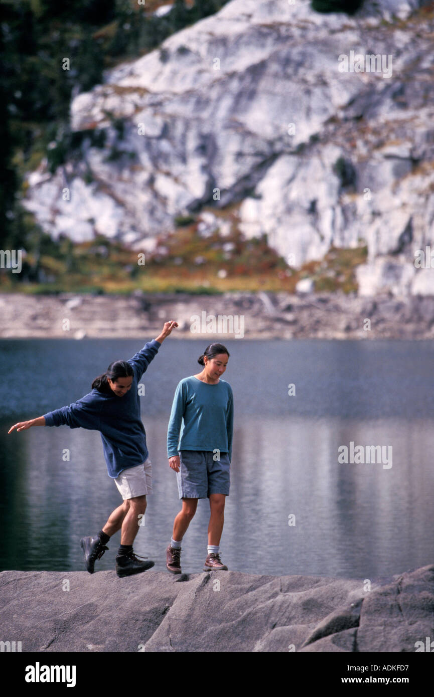 Couple Playing on Rock Together Stock Photo - Alamy