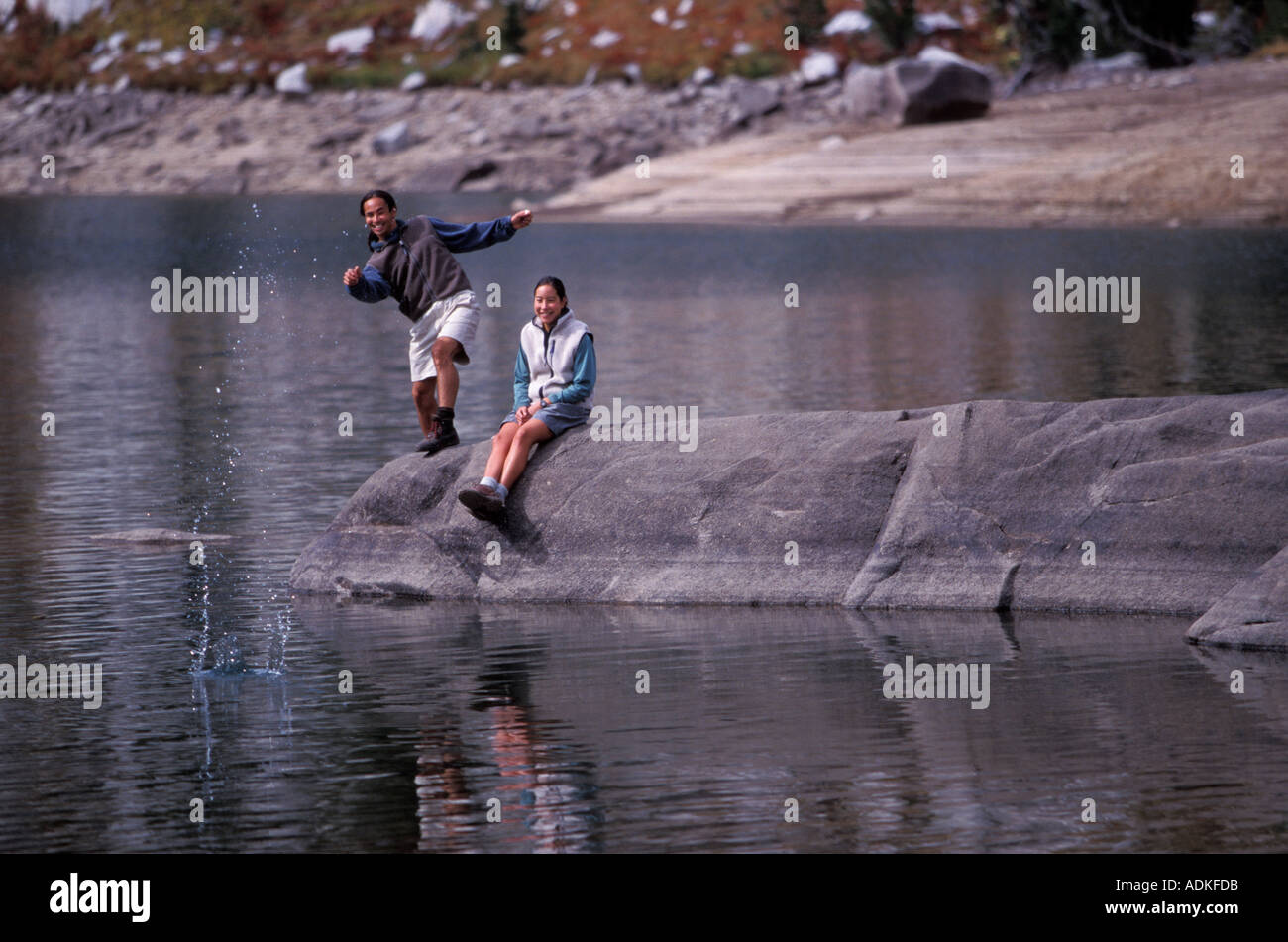 Couple Skipping Rocks Together Stock Photo - Alamy