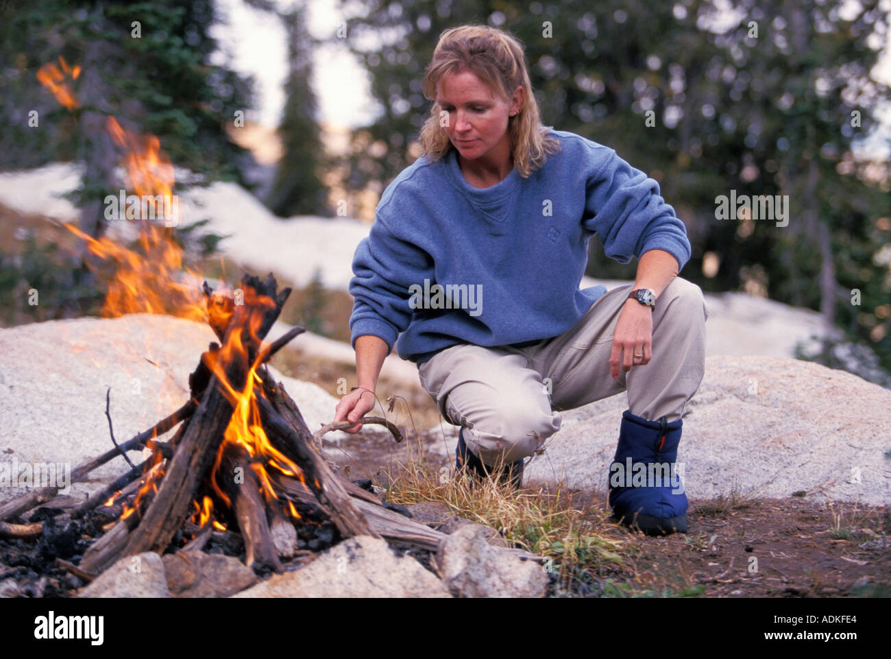Woman Building a Campfire Stock Photo - Alamy