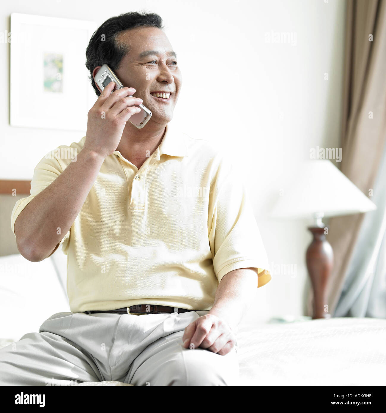 a calling old man on a bed Stock Photo - Alamy