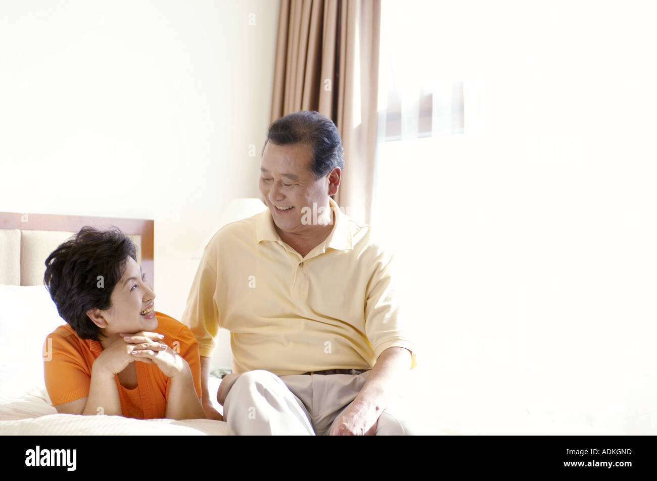an old couple on a bed Stock Photo - Alamy
