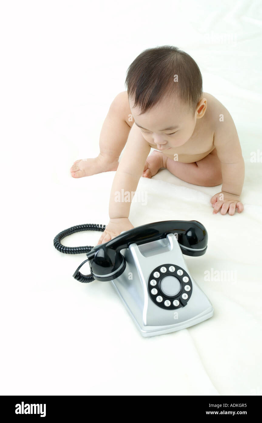 a baby in front of a telephone Stock Photo - Alamy