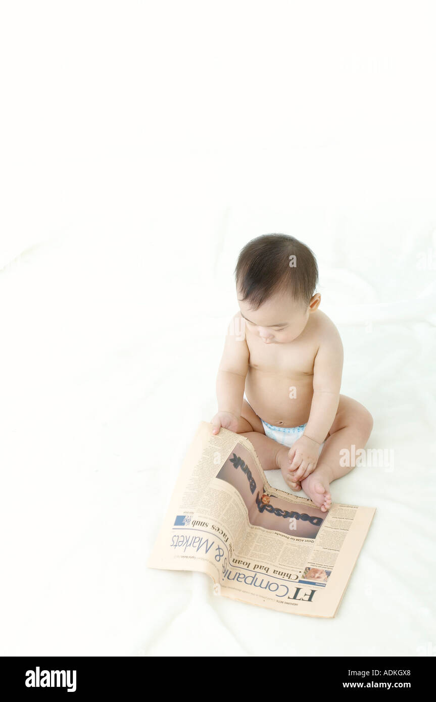 a baby reading a newspaper Stock Photo - Alamy