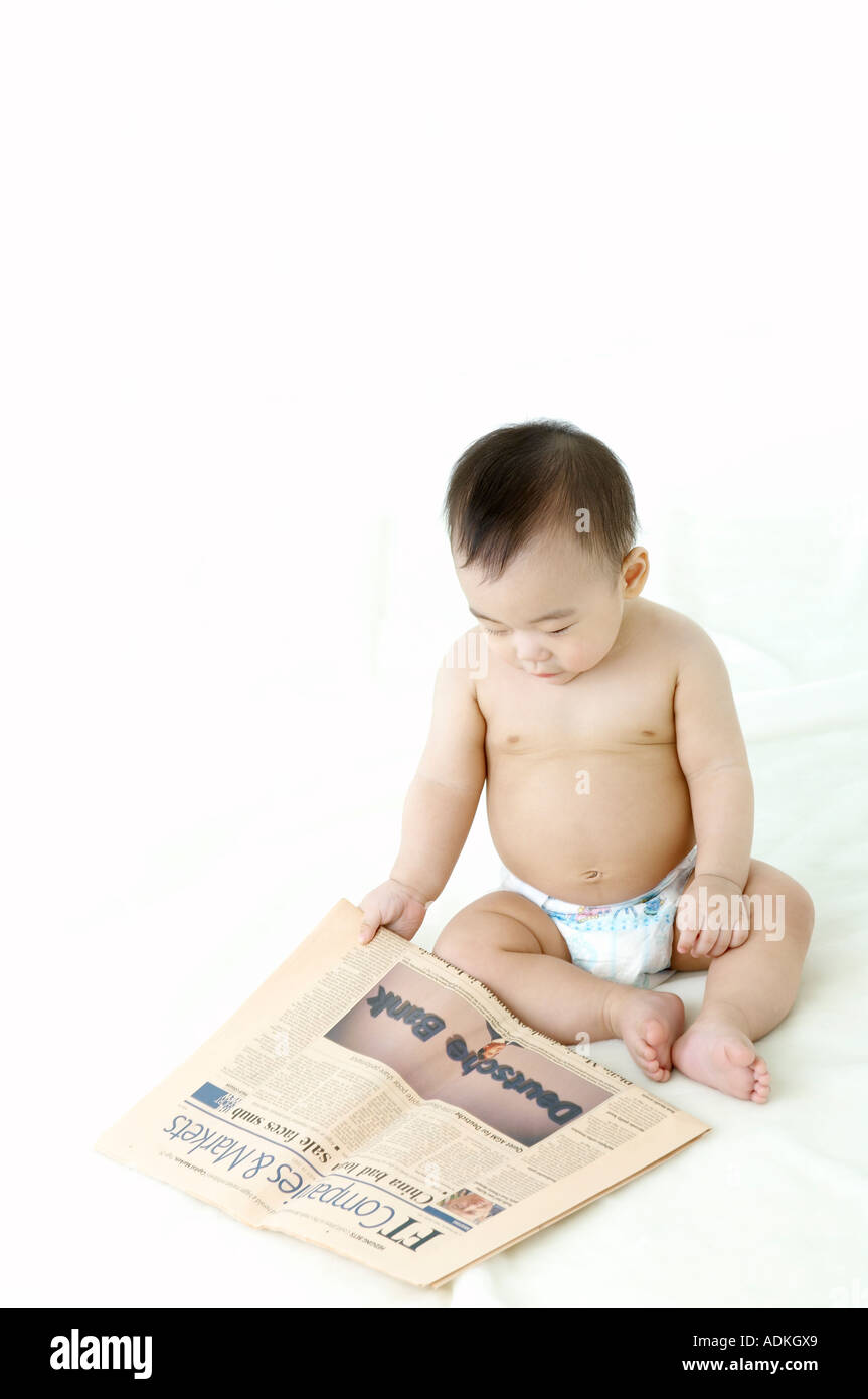 a baby reading a newspaper Stock Photo - Alamy