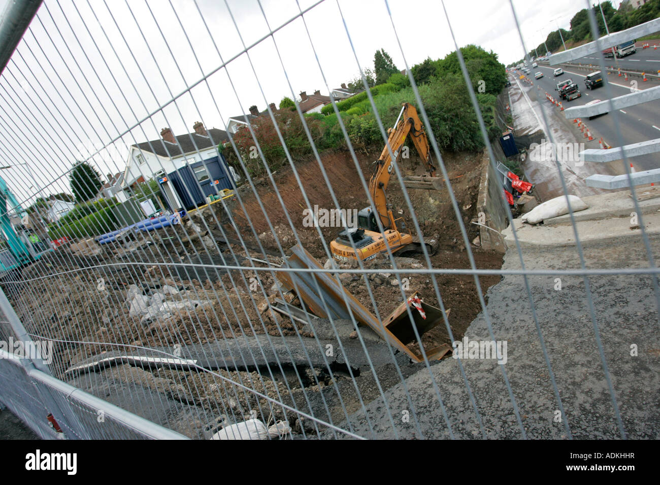 metal fence around construction work due to collapsed motorway bridge ...