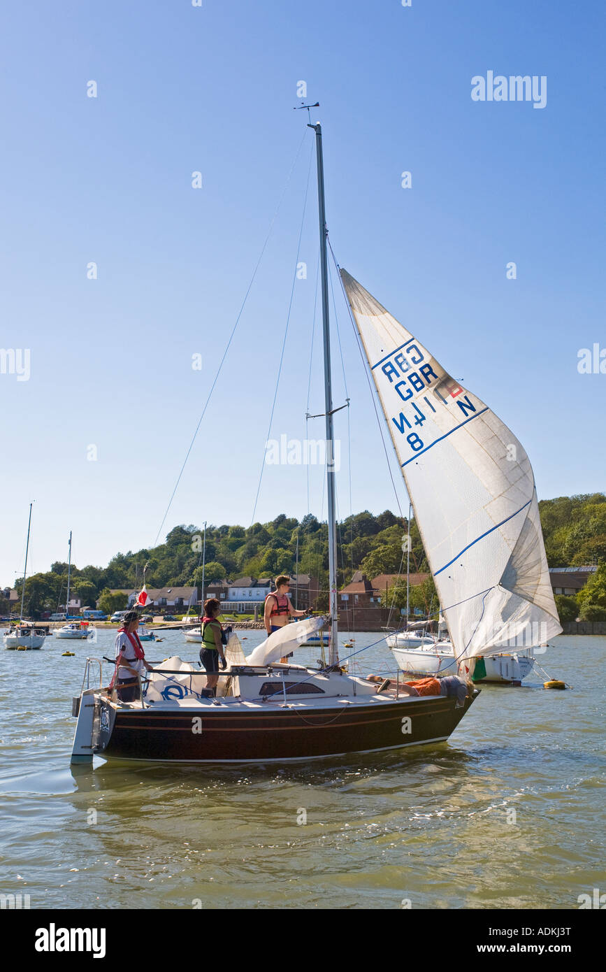 A small racing sailing boat attempting to sail onto its mooring on the ...