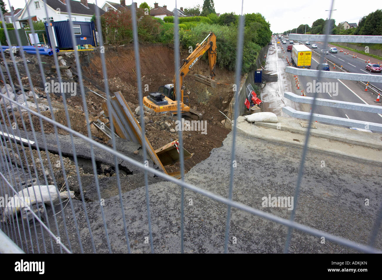 looking through metal fence at construction work due to collapsed ...