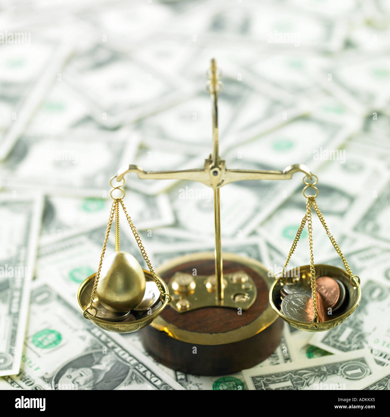 finance a scale and golden egg coins on a paper money Stock Photo - Alamy