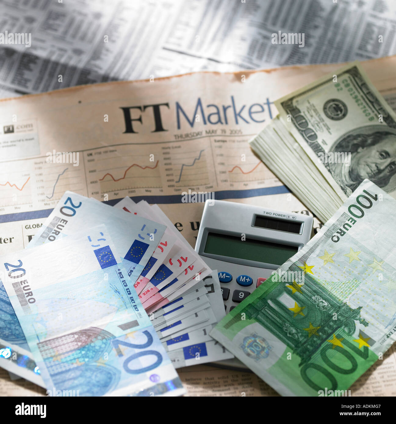 finance paper money and a calculator on a newspaper Stock Photo - Alamy