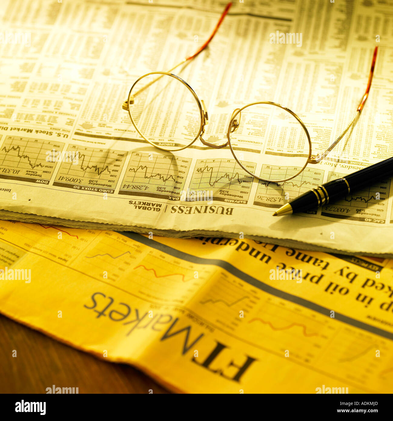 business article a newspaper and a glasses pen Stock Photo - Alamy