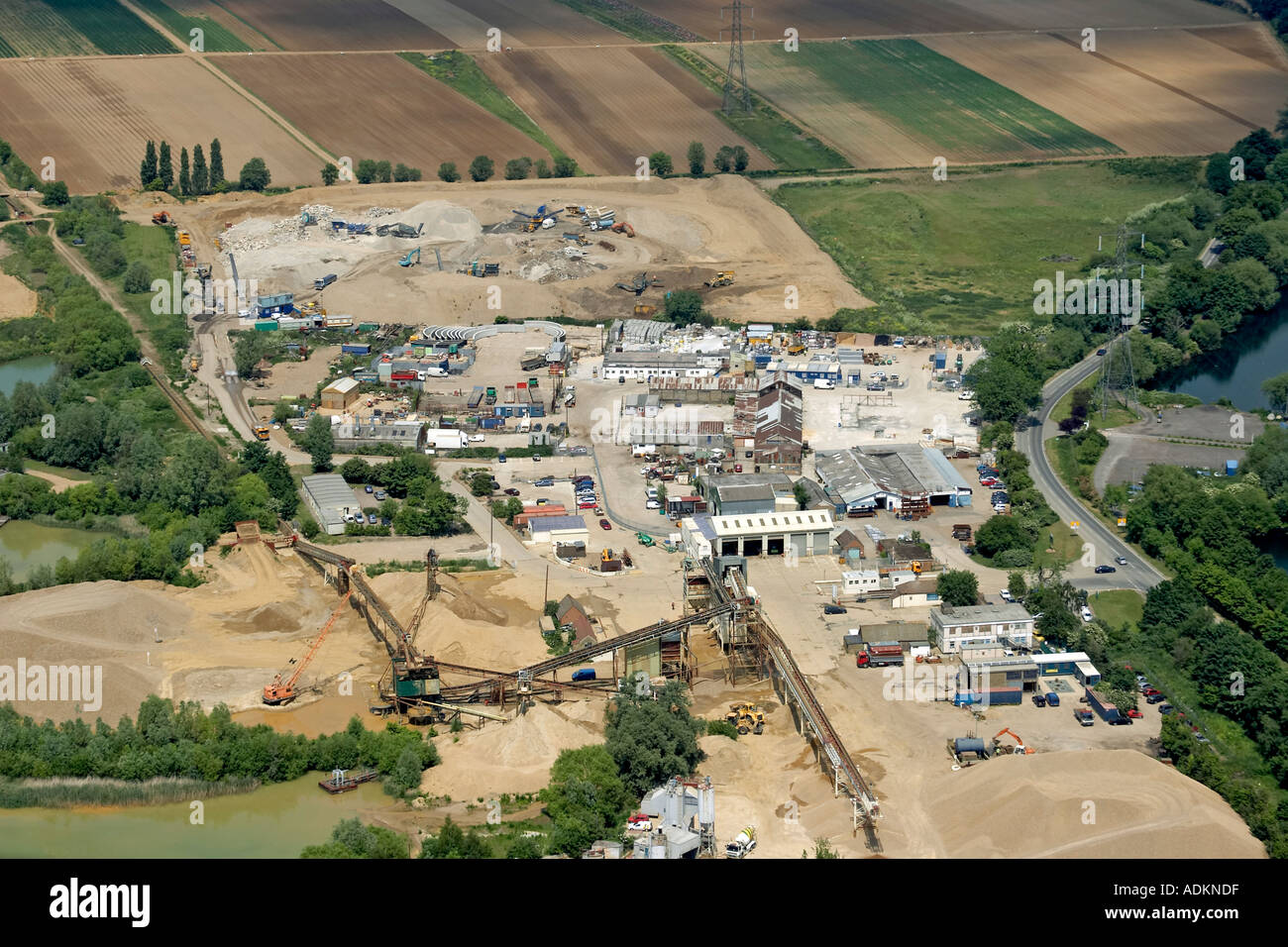 Oblique high level aerial view north of Addlestone with a gravel pit ...