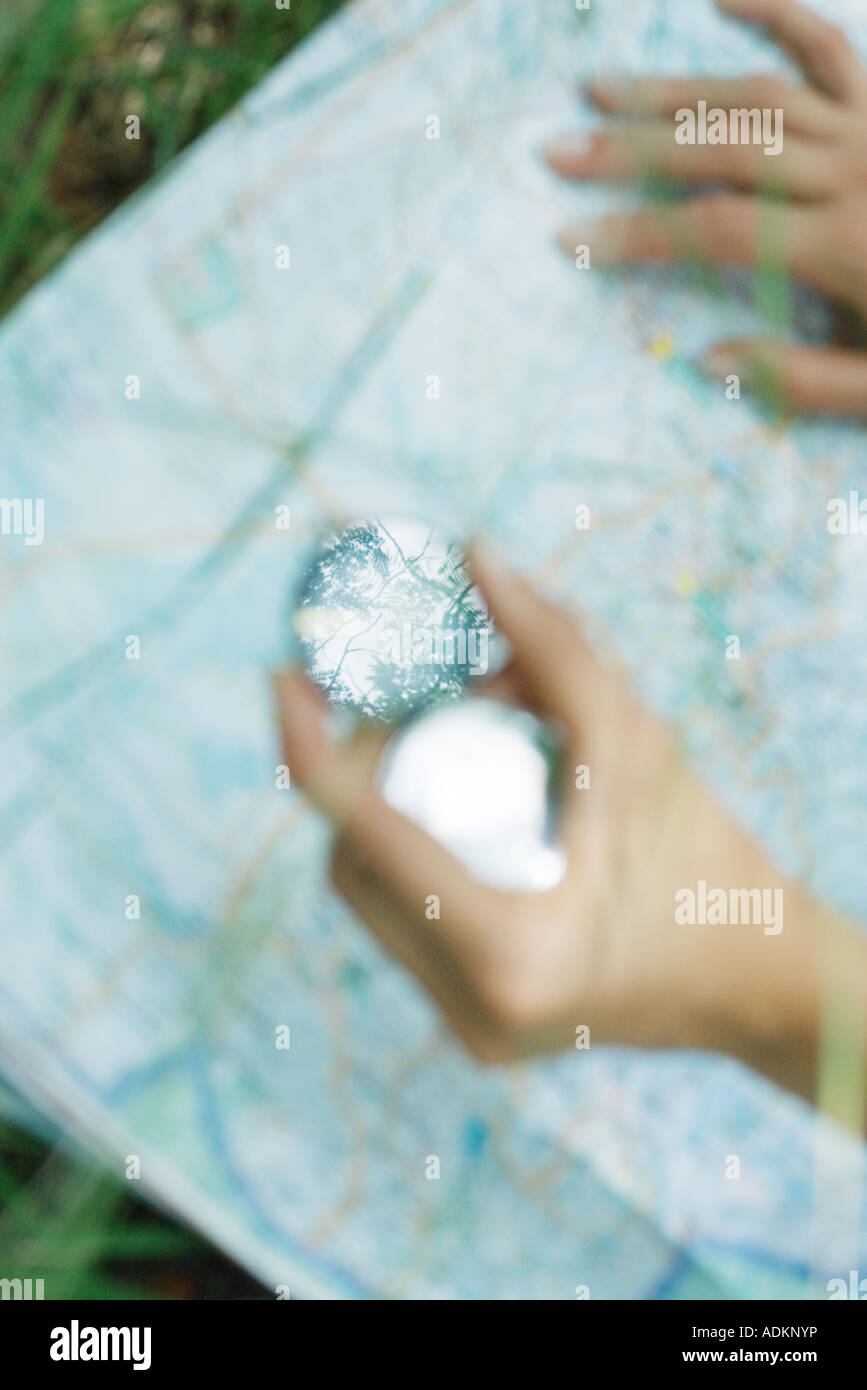 Person studying map and holding compass, cropped view of hands ...