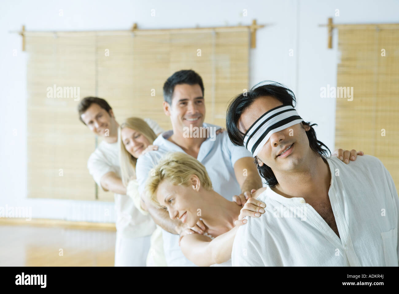 Group therapy, standing in single file line with hands on each other's ...